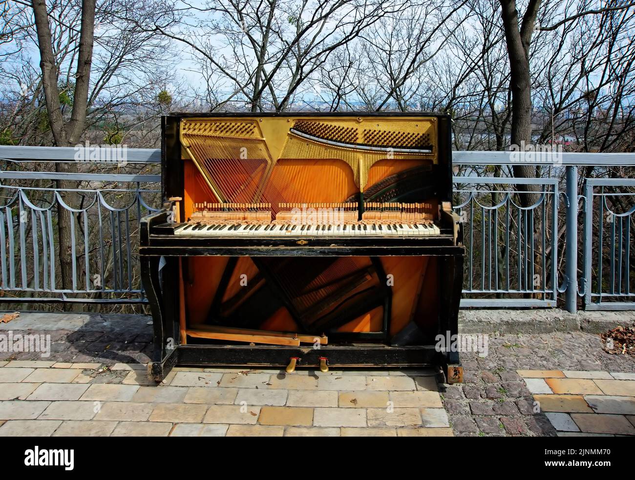 Dumped and damaged vintage upright piano with the internal parts ...