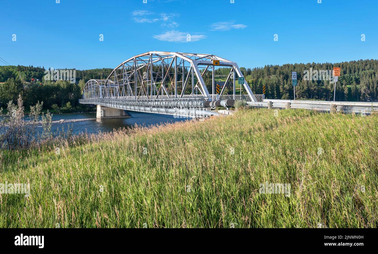 Old steel truss bridge crossing the Bow River at the town of Cochrane ...
