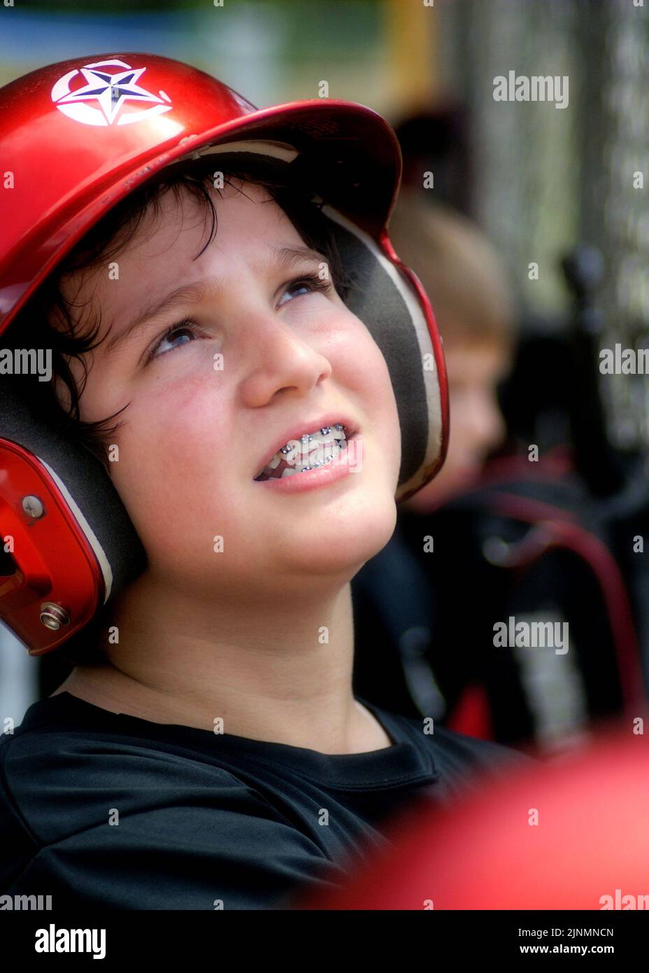 Young, relaxed baseball player enjoying a calm dugout moment Stock ...
