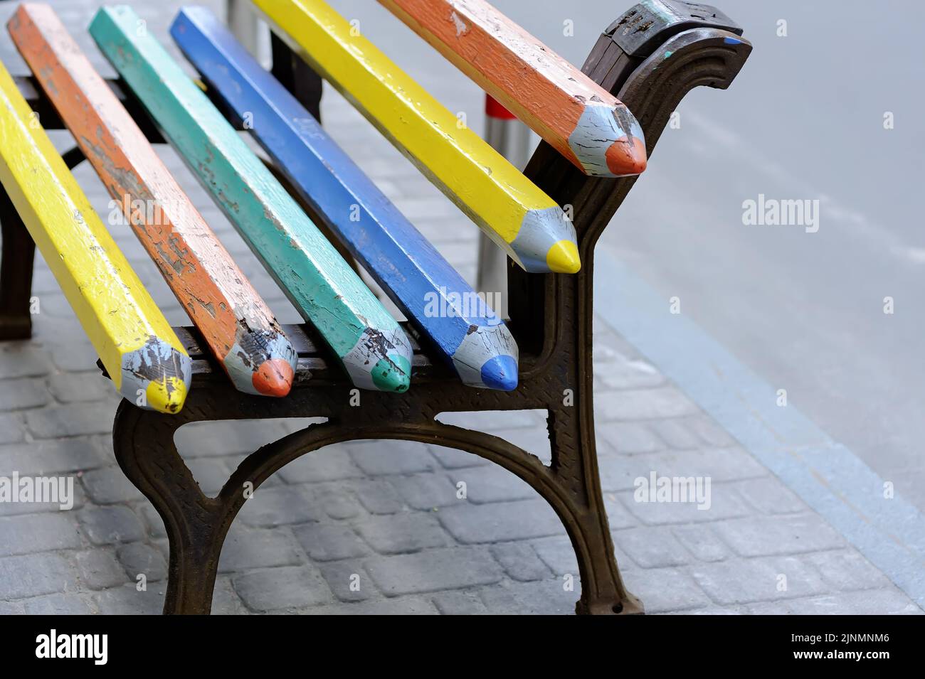 Multicolored bench made of boards in the form of colored pencils on ...