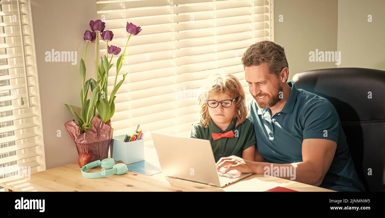 happy dad helping his school son child in glasses study with computer ...