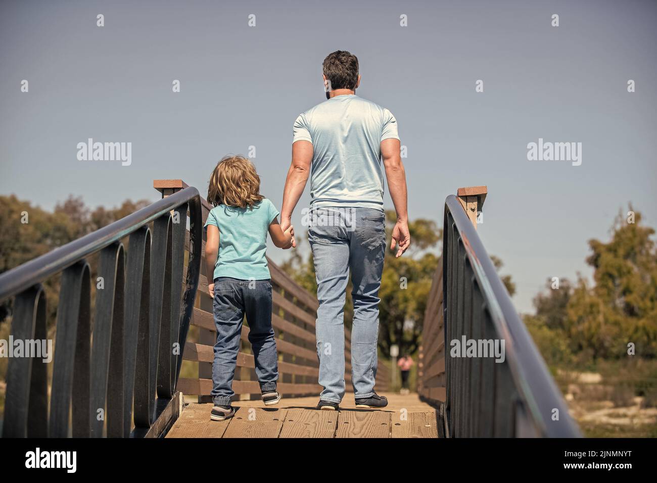 single dad leading small child outside back view, childhood Stock Photo ...