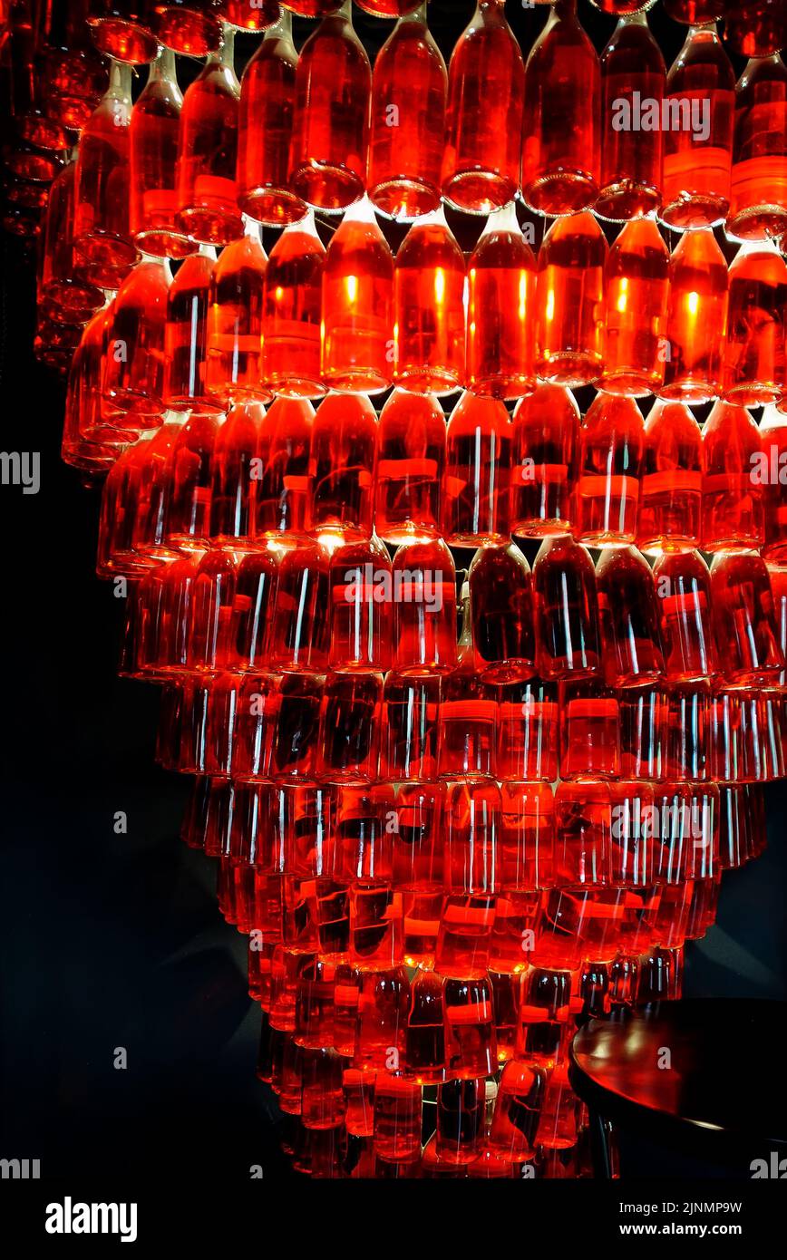 Turned up pyramid of highlighted glass bottles Stock Photo - Alamy