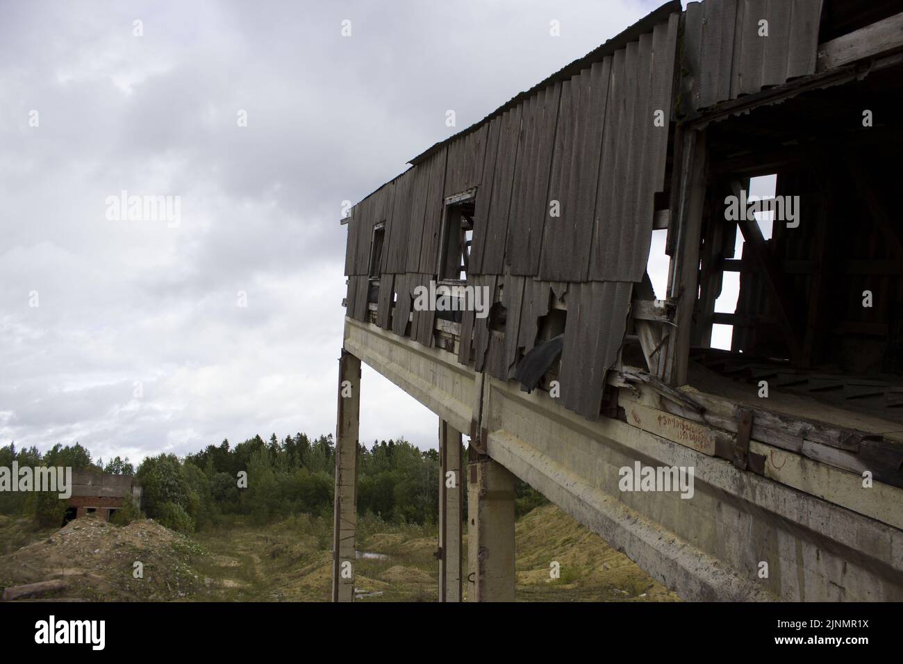 stairs leading to heaven. ruined industrial building on stilts with a ...