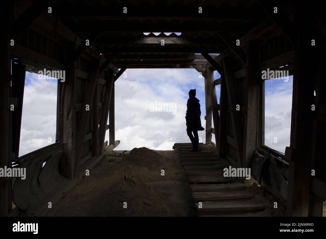 stairs leading to heaven. ruined industrial building on stilts with a ...
