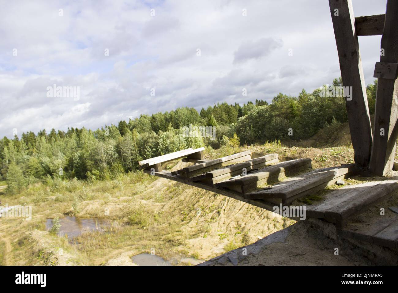 stairs leading to heaven. ruined industrial building on stilts with a ...