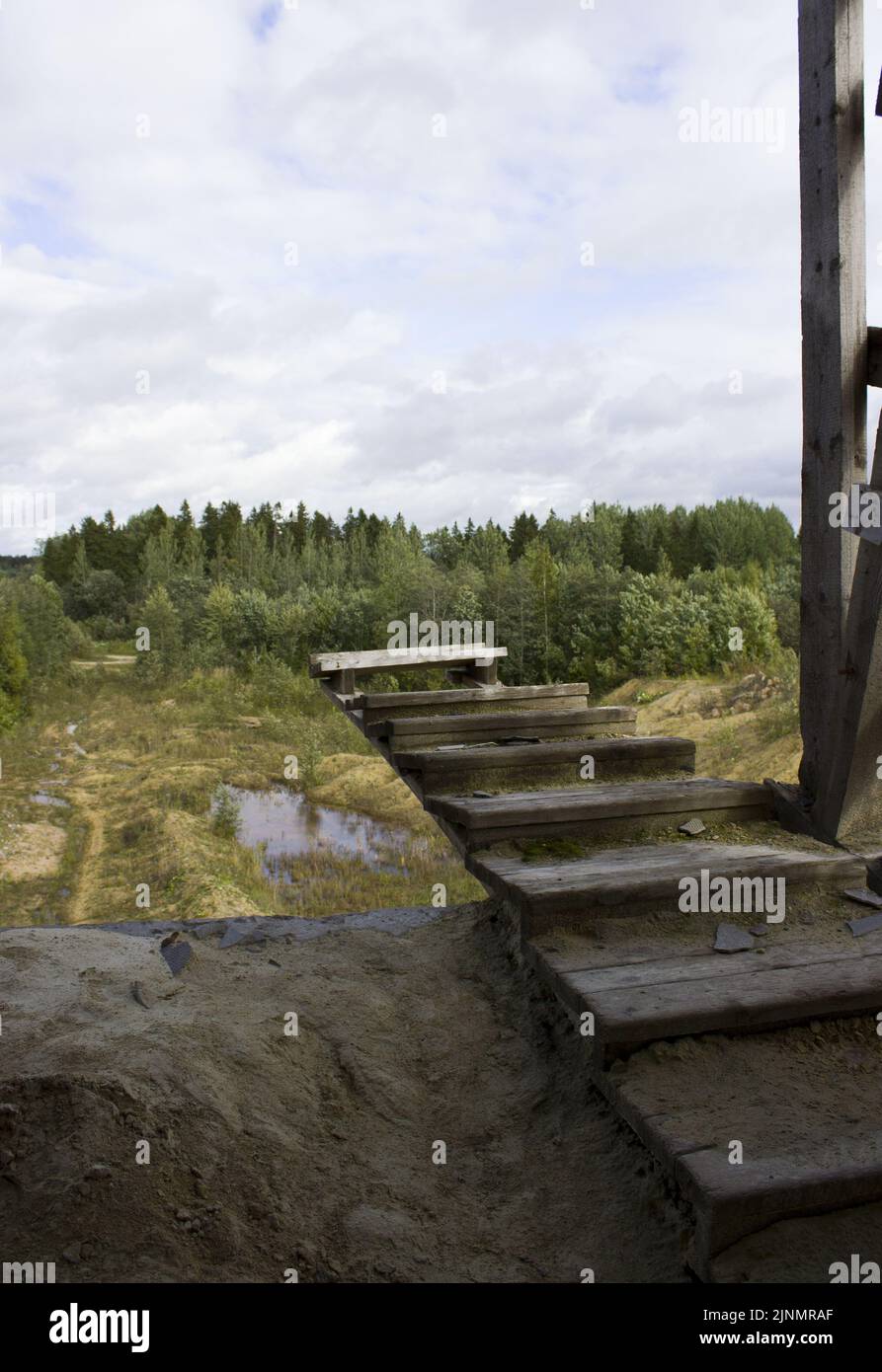 stairs leading to heaven. ruined industrial building on stilts with a ...