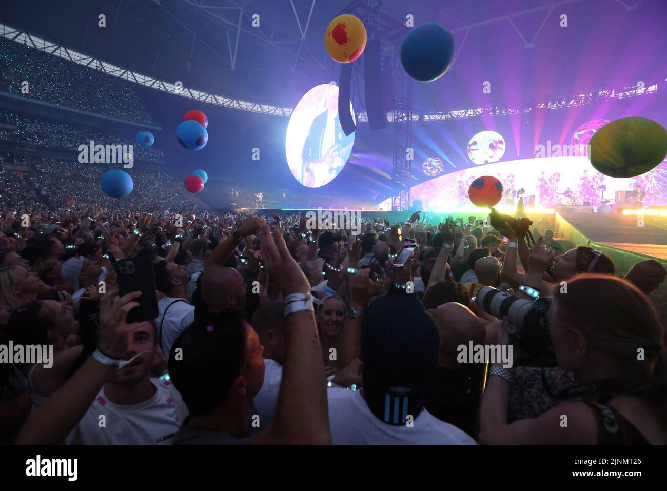 The crowd whilst Coldplay performing on stage at Wembley Stadium, north ...
