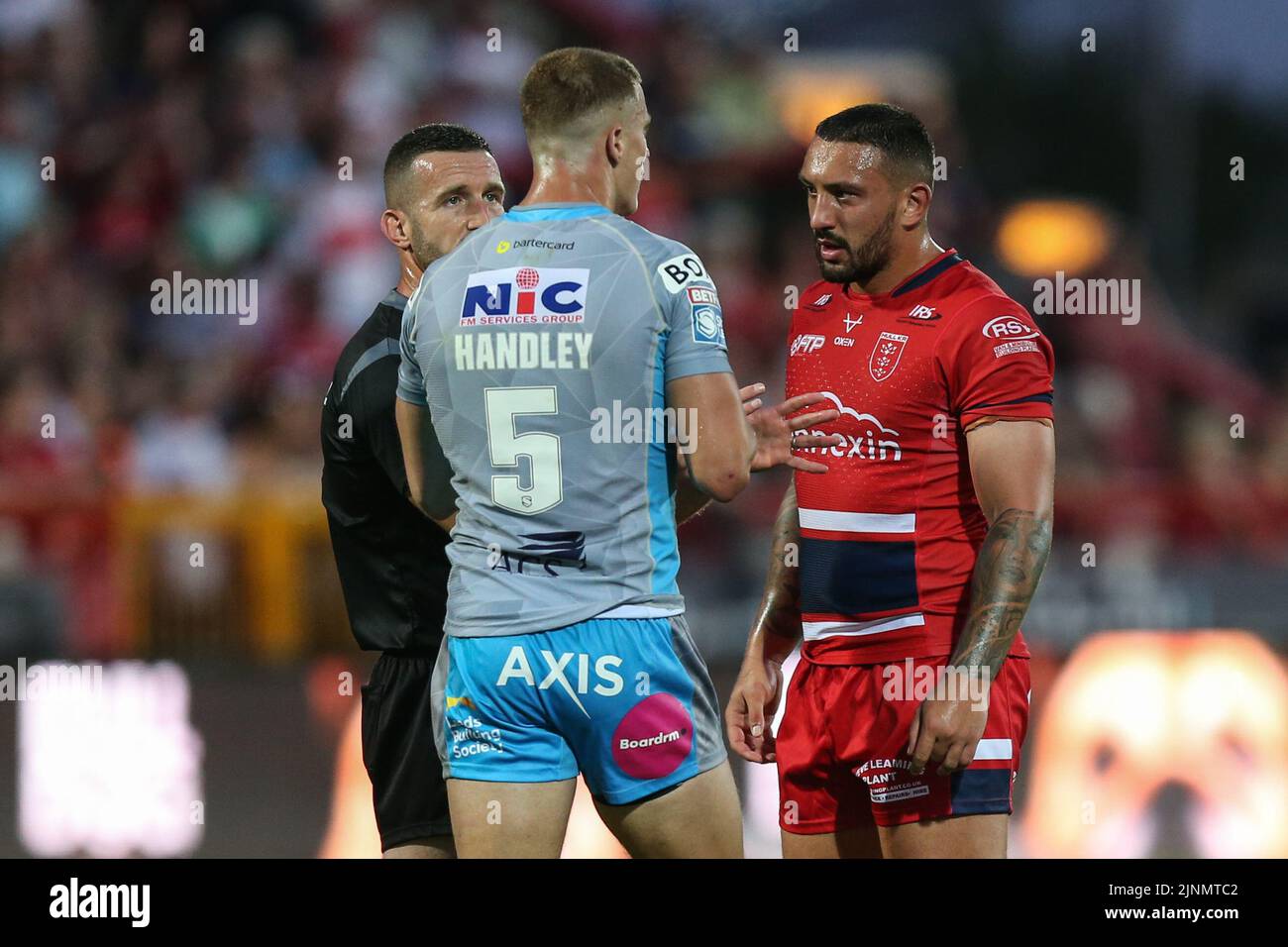Referee Jack Smith speaks to Ash Handley #5 of Leeds Rhinos and Elliot ...