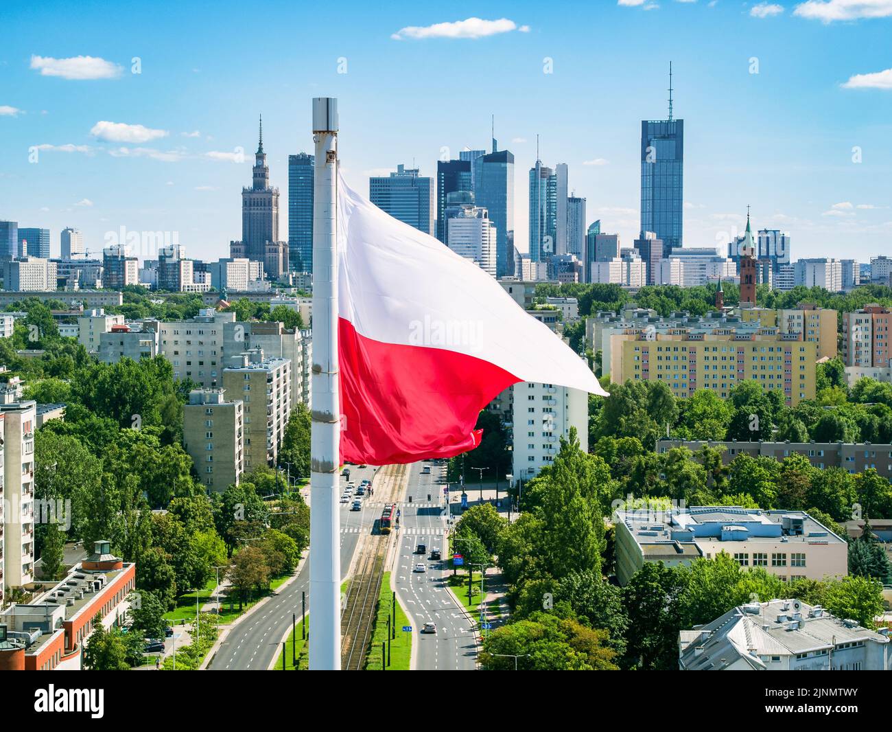 Polish national flag against skyscrapers in Warsaw city center, aerial ...