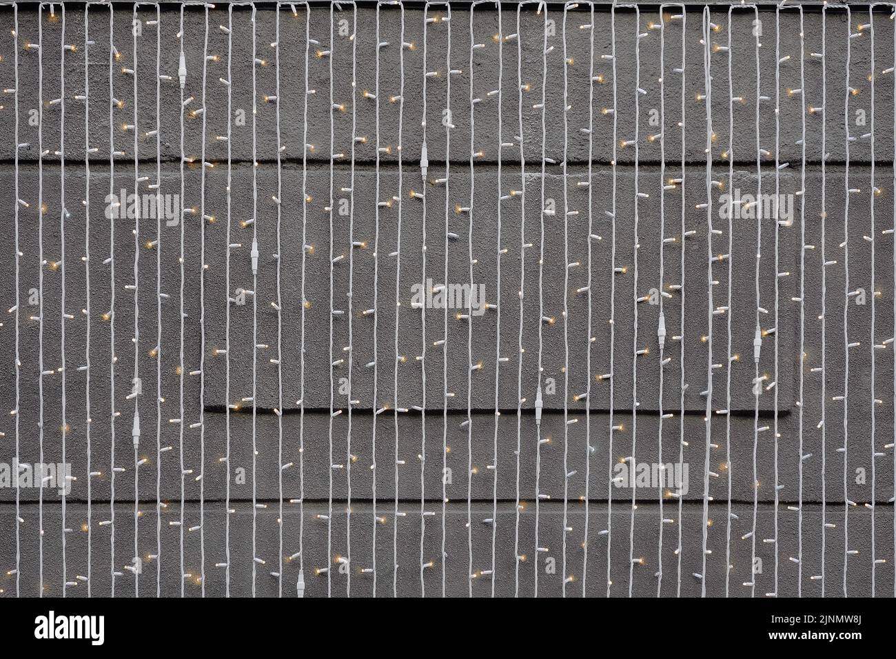 Gray wall covered with simple yellow neon streetlights in Kyiv Ukraine ...