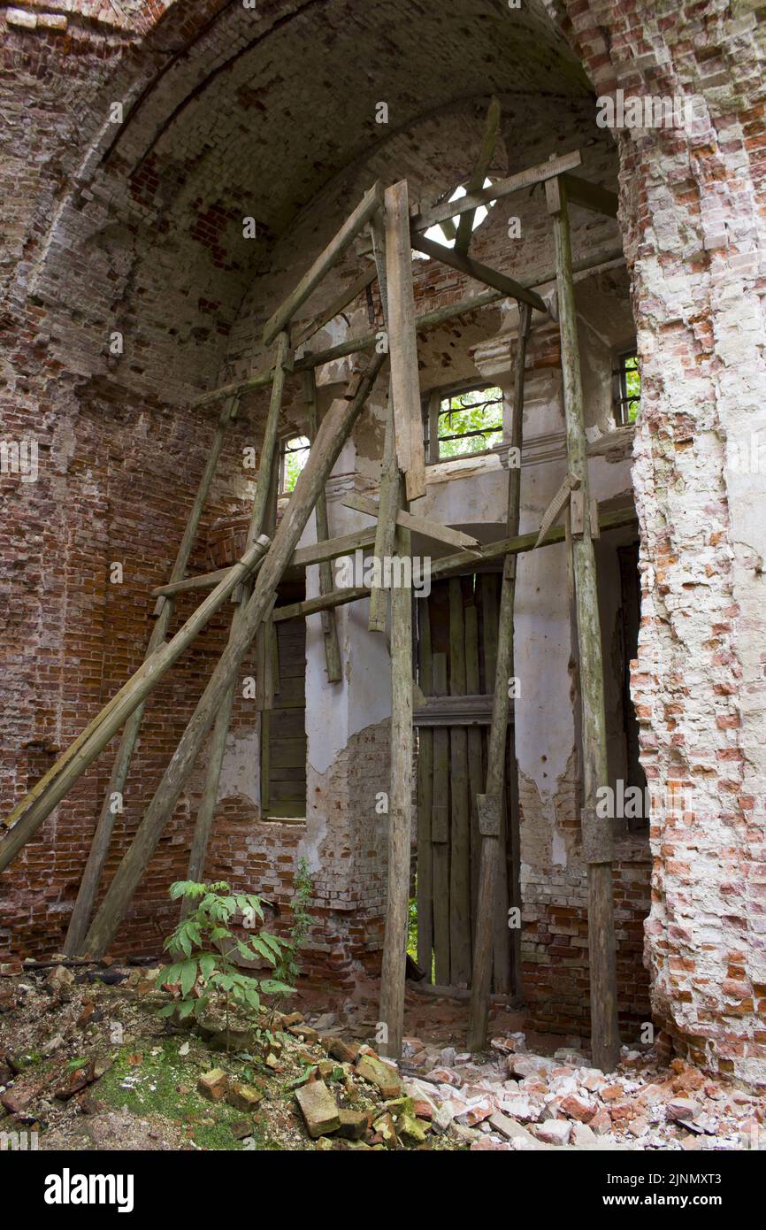 wooden scaffolding and beams in a ruined brick old church. Attempts to ...