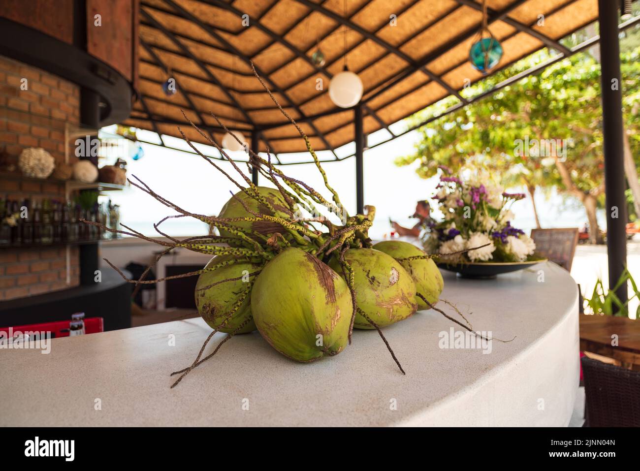 Fresh coconut in the open air bar. Beautiful fruits of tropical beaches ...