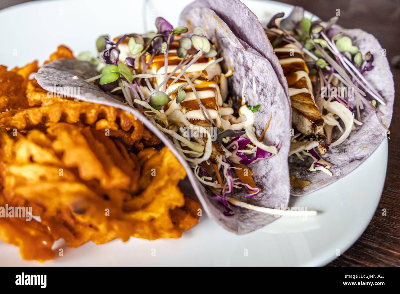 Ube tortilla fish tacos witha side of crispy waffle sweet potato fries ...