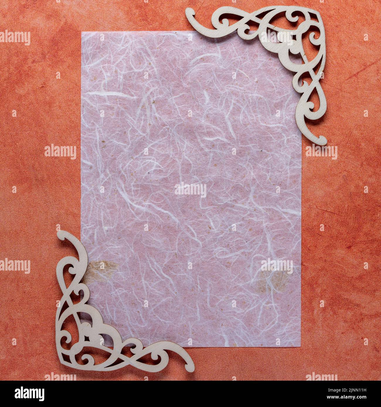 fiber paper with wood decor corners on a textured orange background in ...