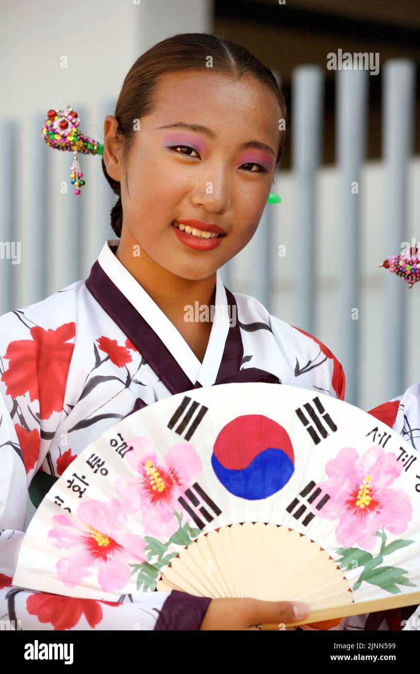 A portrait photo of a Korean dancer in a hanbok with a fan, at a ...