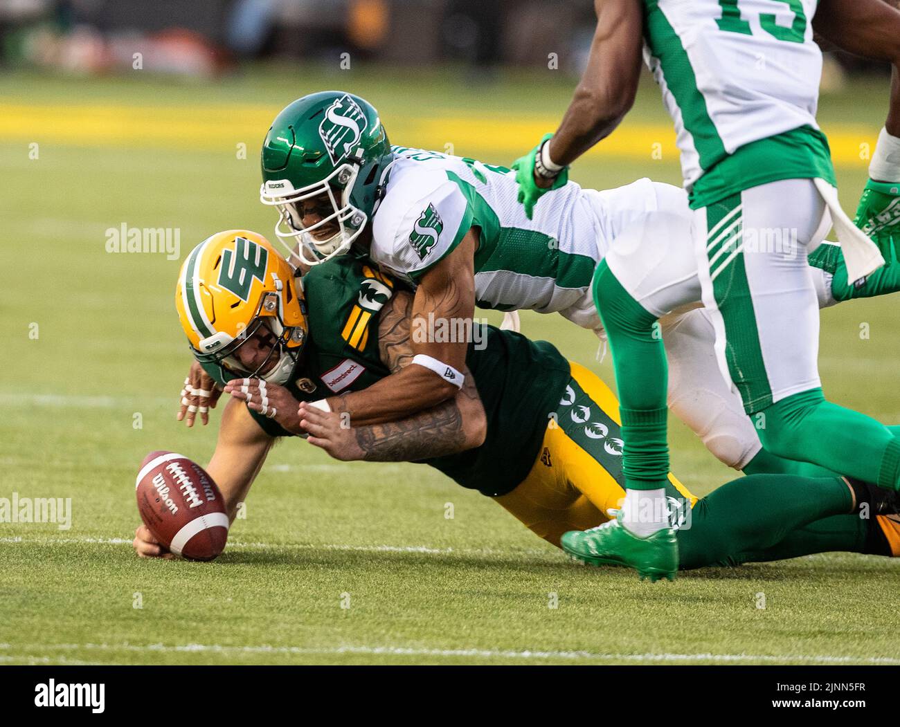 Saskatchewan Roughriders' Jeremy Clark (37) tackles Edmonton Elks' Matt ...