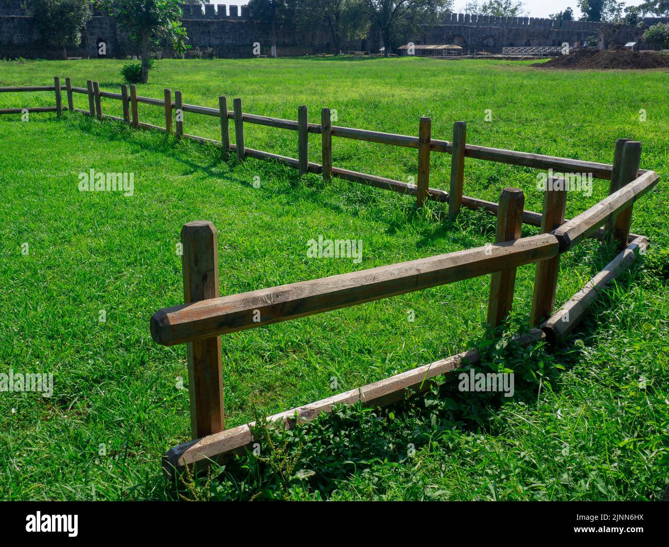 Lawn for grazing horses in the courtyard of a medieval castle. Lawn and ...