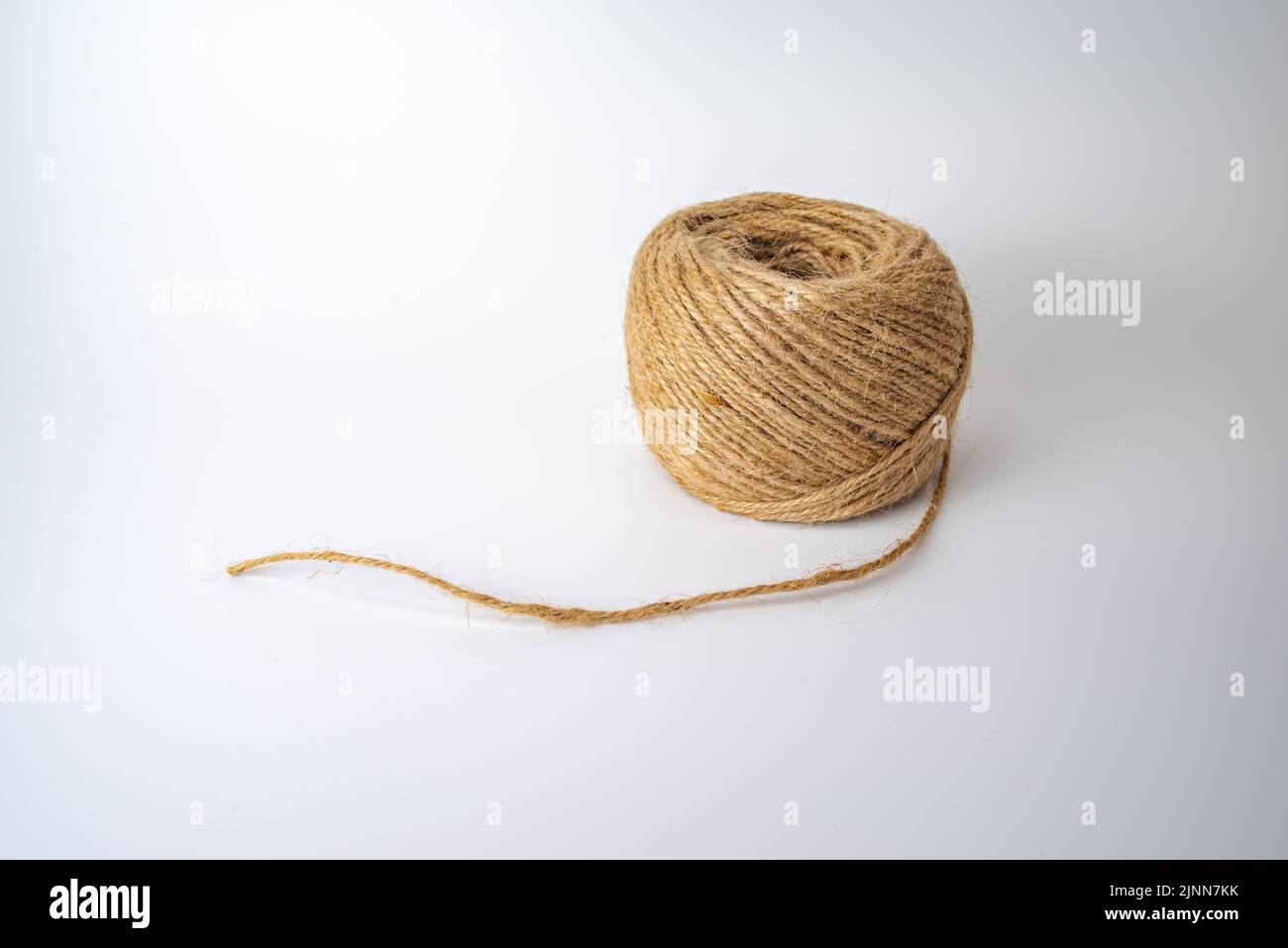 Roll of hemp string isolated on white Stock Photo - Alamy