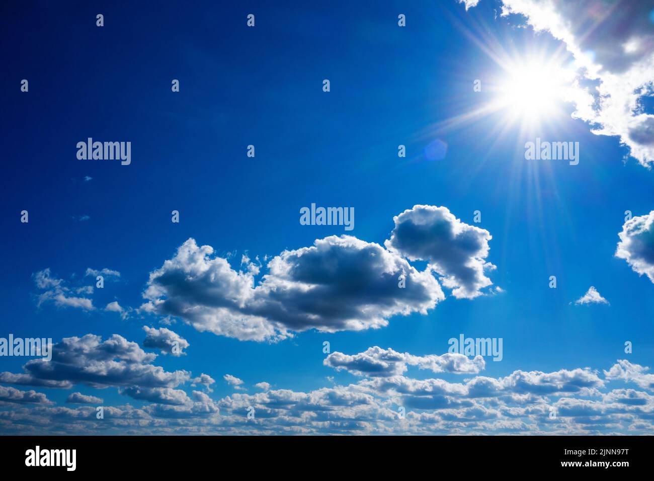 Bright sun in the blue sky. natural background Stock Photo - Alamy