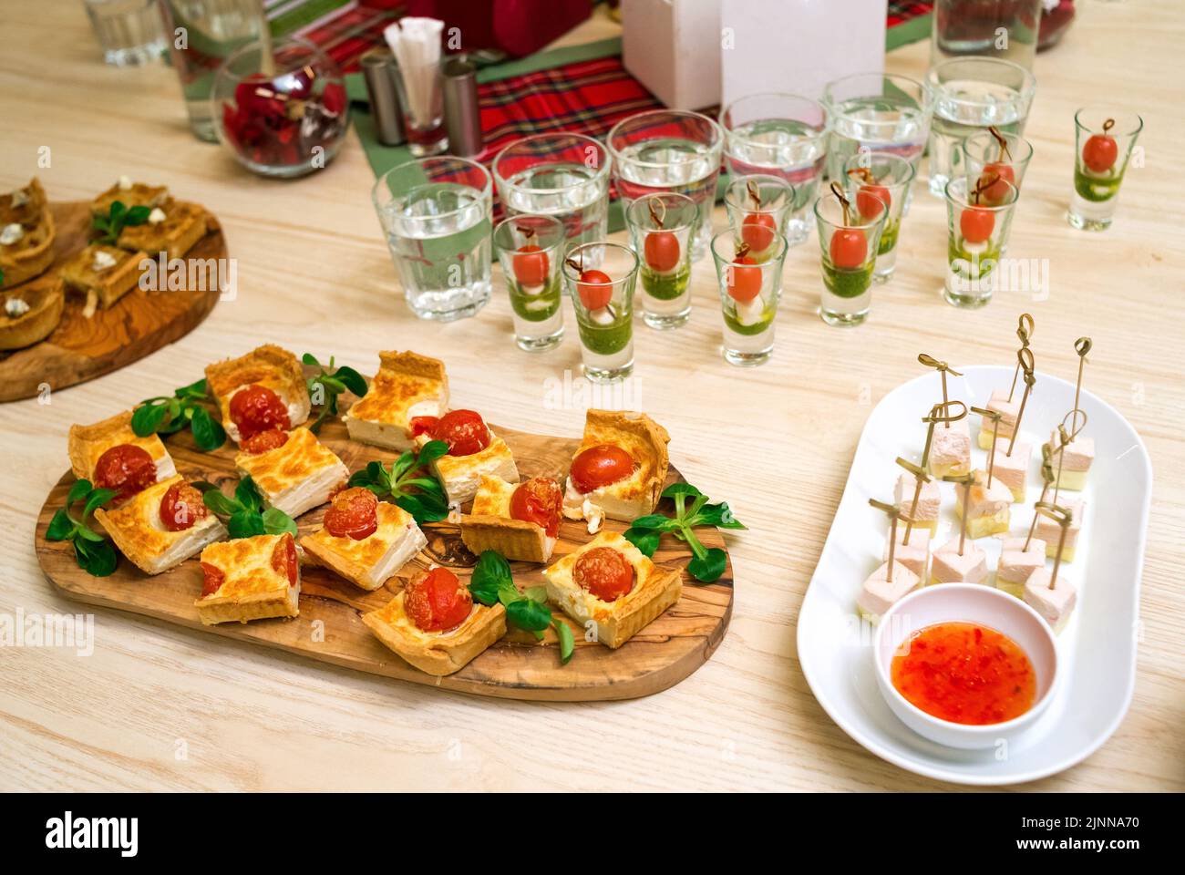 square slices of quiche with cherry tomatoes and corn lettuce leaves on ...