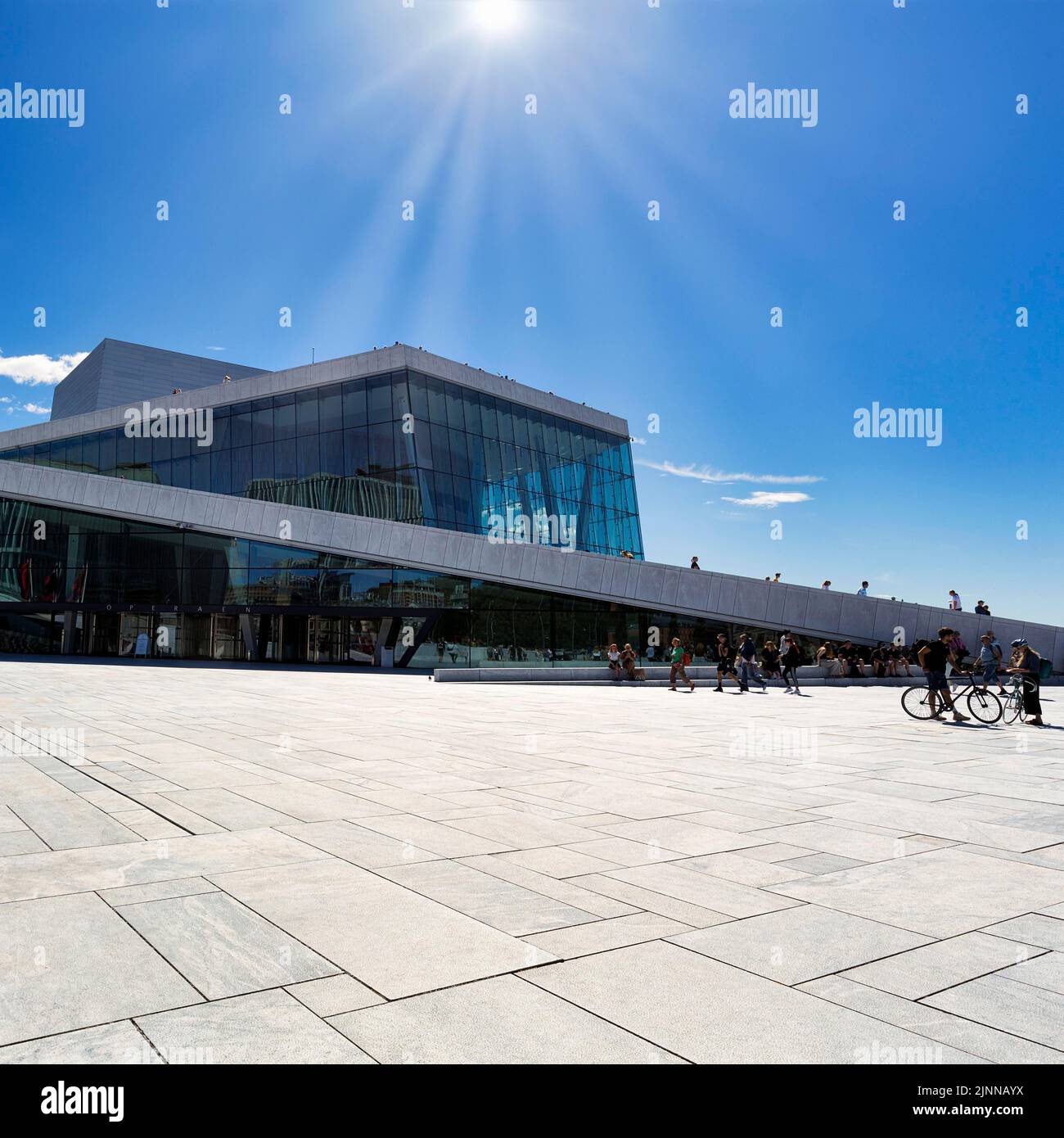 Pedestrians on the white forecourt and roof of the opera house in ...