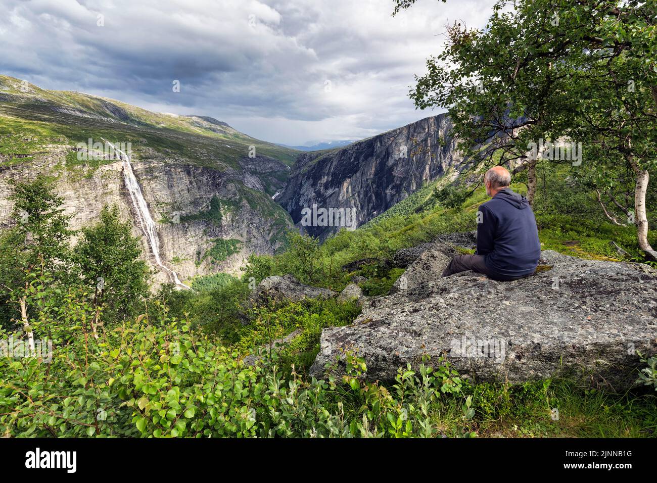 Tourist enjoying view, mountain view of Aurstaupet waterfall ...