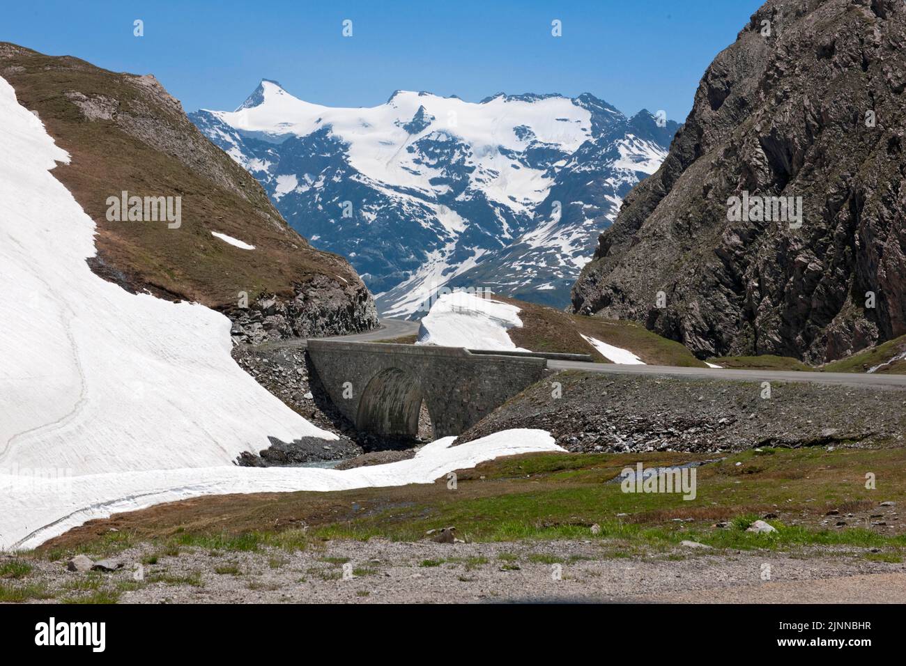Bridge of mountain road in high Alps over glacier runoff of eternal ...