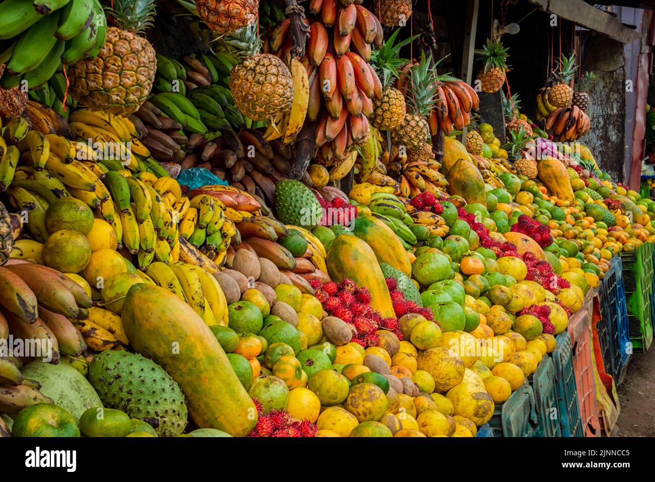 View of a traditional fruit stall. Shelf with variety of fresh fruits ...
