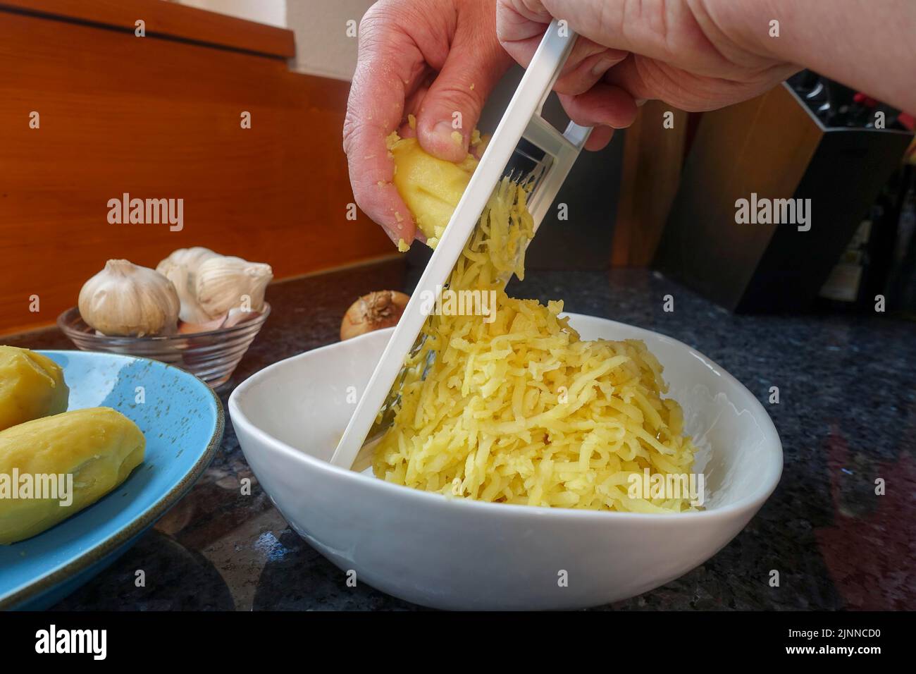 Swabian cuisine, preparing Haertsfeld potato cake, grating boiled ...