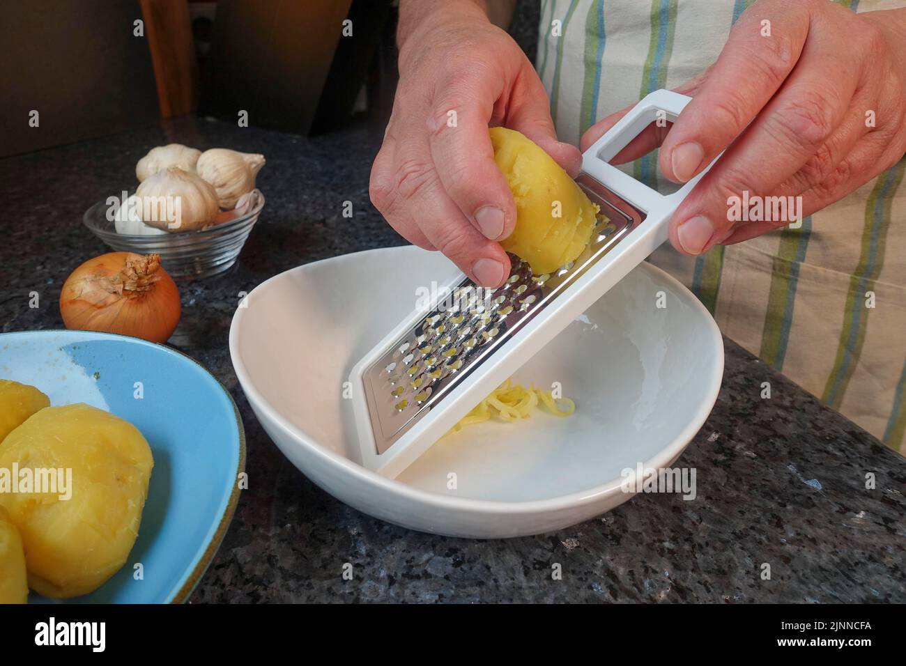 Swabian cuisine, preparing Haertsfeld potato cake, grating boiled ...
