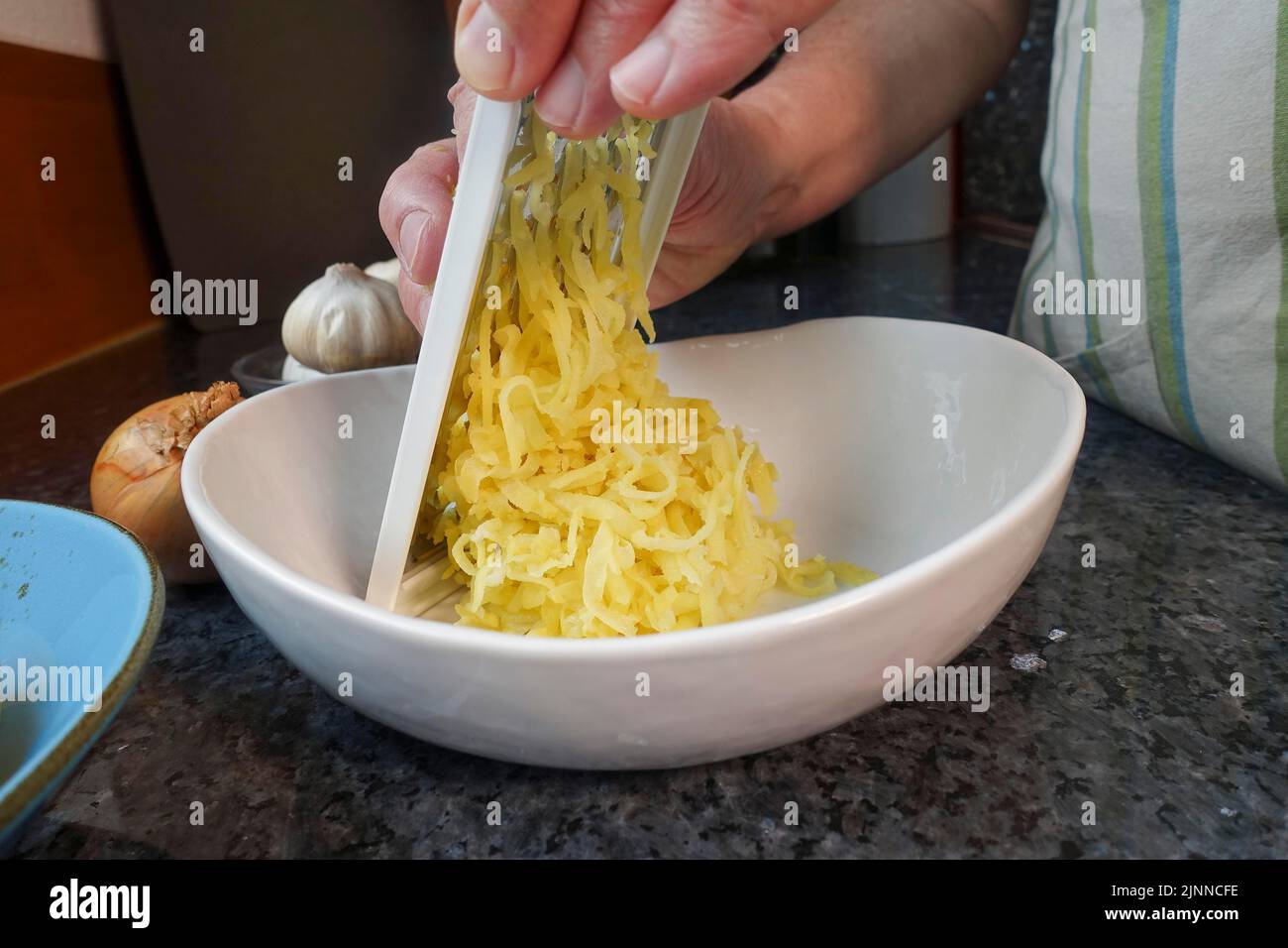 Swabian cuisine, preparing Haertsfeld potato cake, grating boiled ...