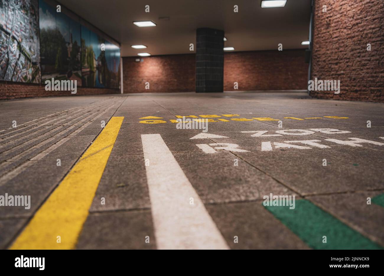 Deep ground shot at night, in a subway with symbols on the floor ...