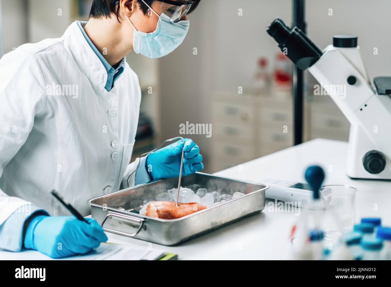 Quality control inspector testing fish Stock Photo - Alamy