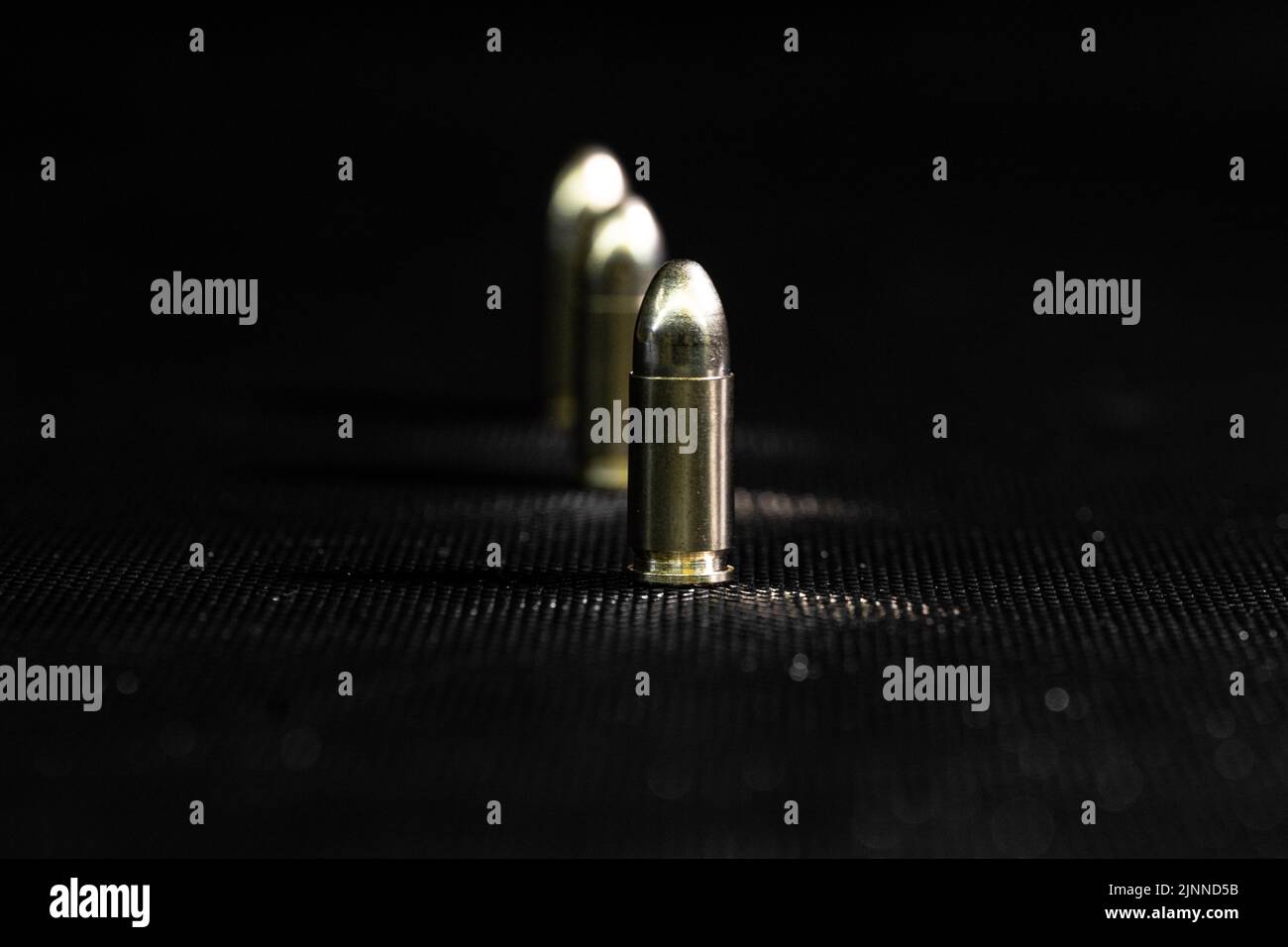 Three gun shells of a gun on a black background, Germany Stock Photo ...