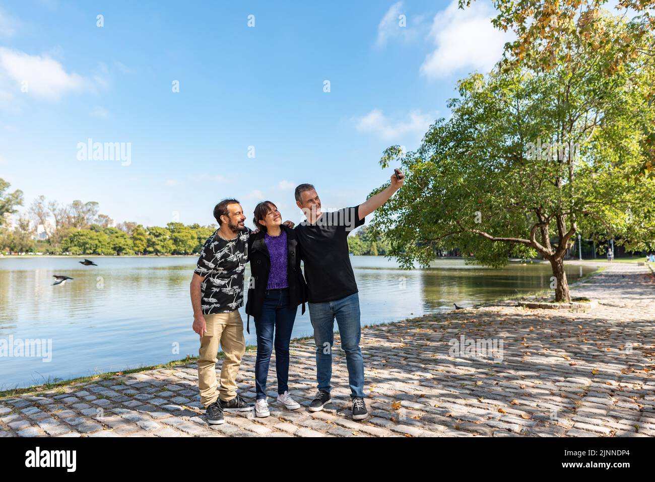 A group of friends taking selfies outdoors Stock Photo - Alamy