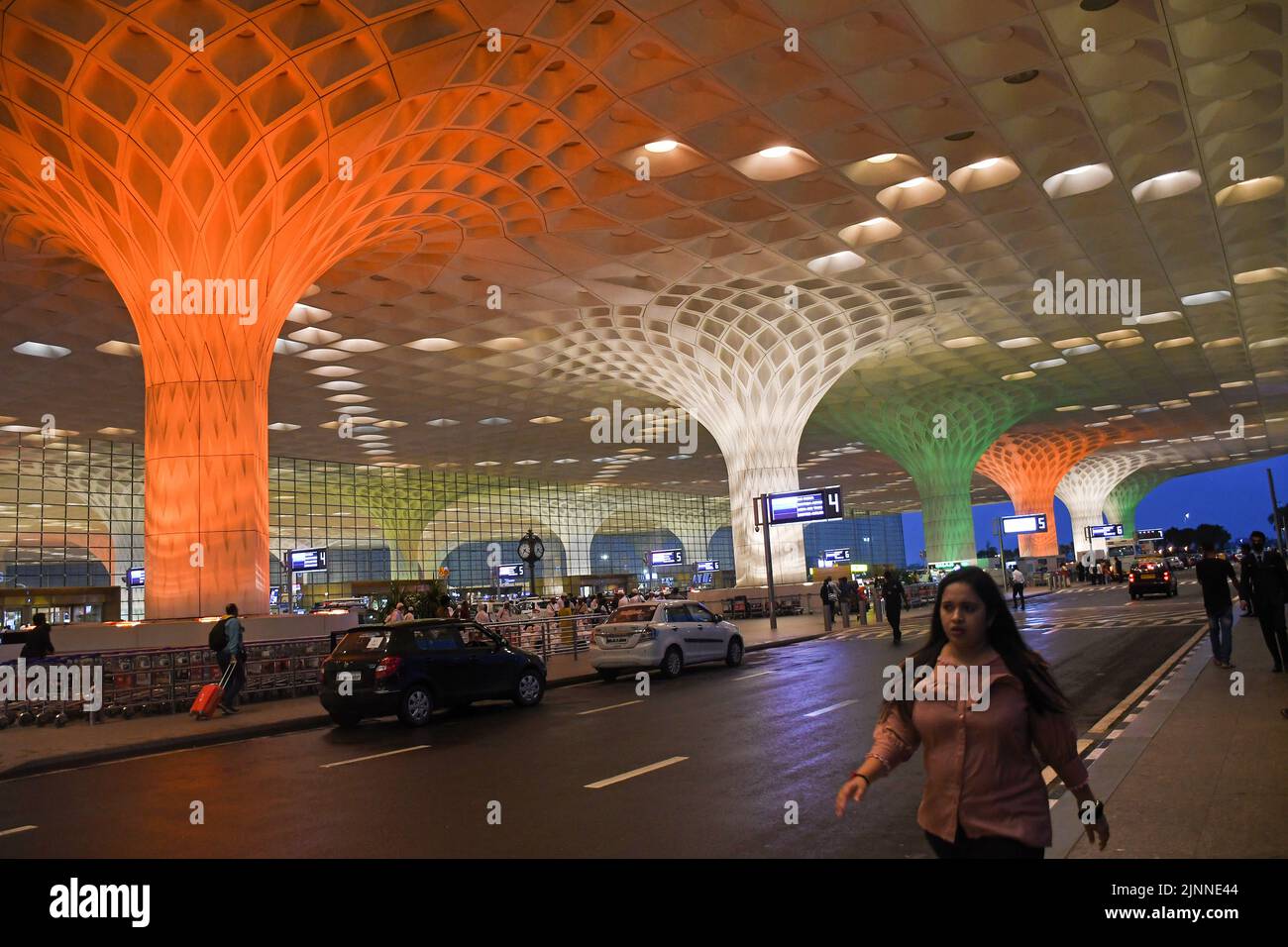 A woman walks on a sidewalk at Chhatrapati Shivaji Maharaj ...