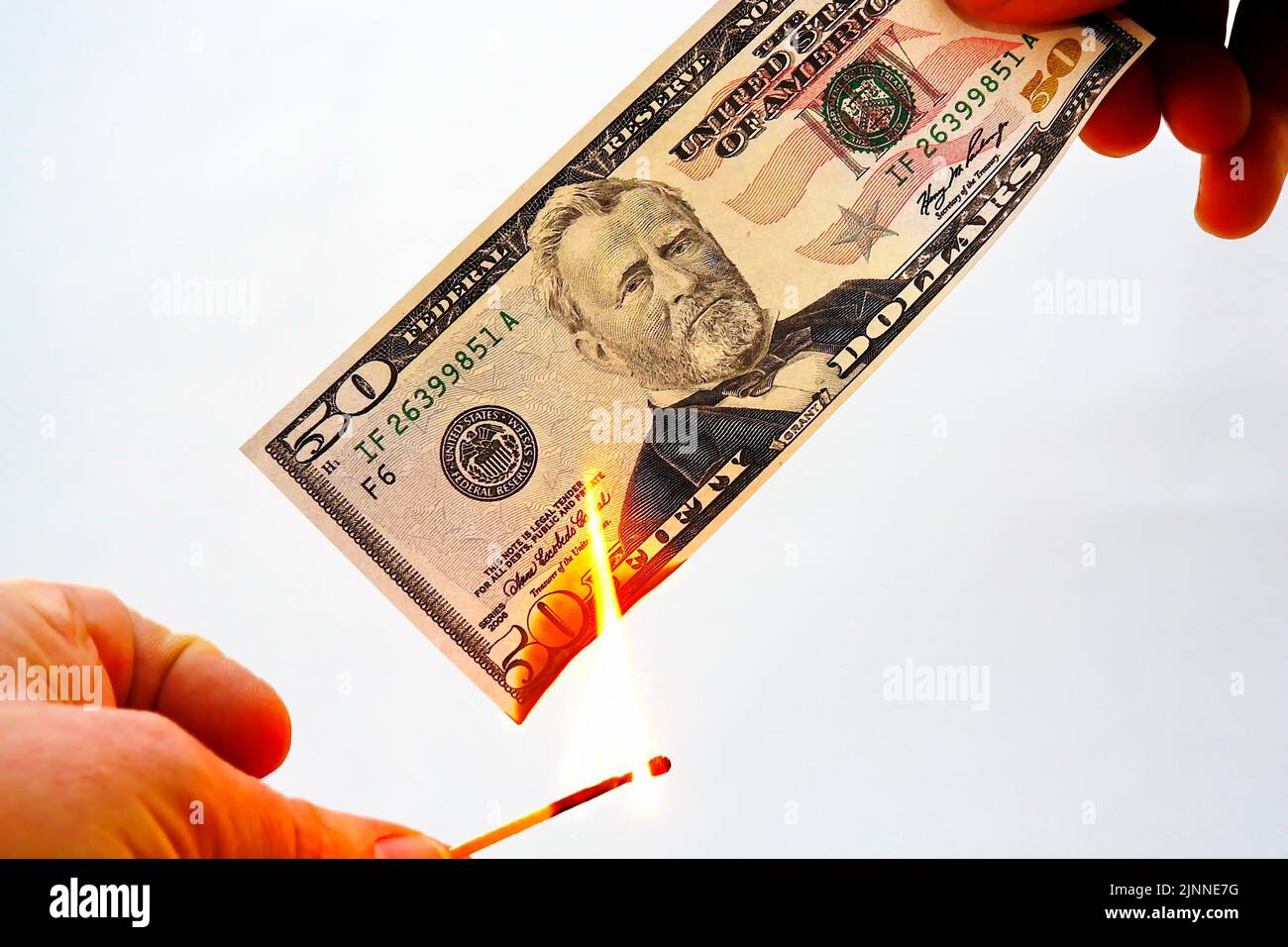 Lighting a fifty dollar note on fire and burning it. Released against a ...
