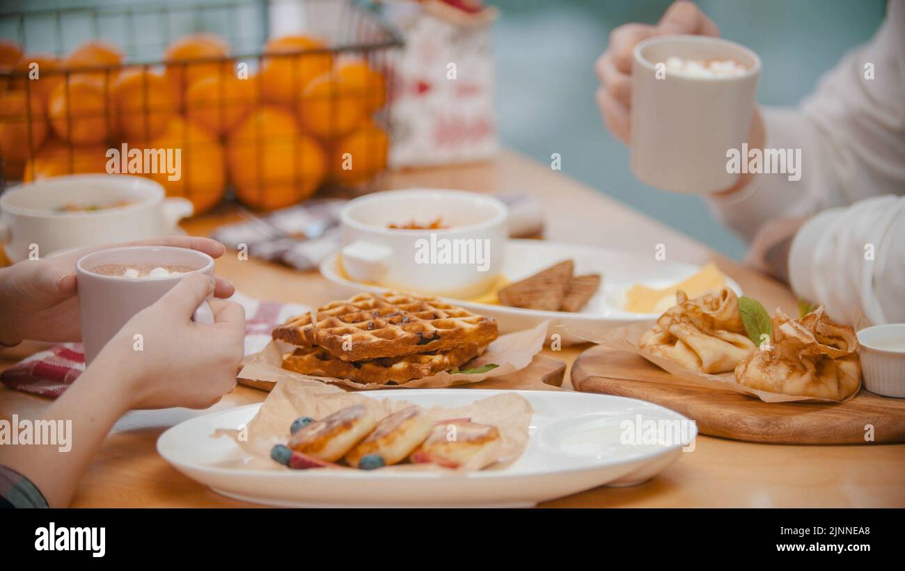 A couple in restaurant having a breakfast of waffles and pancakes Stock ...