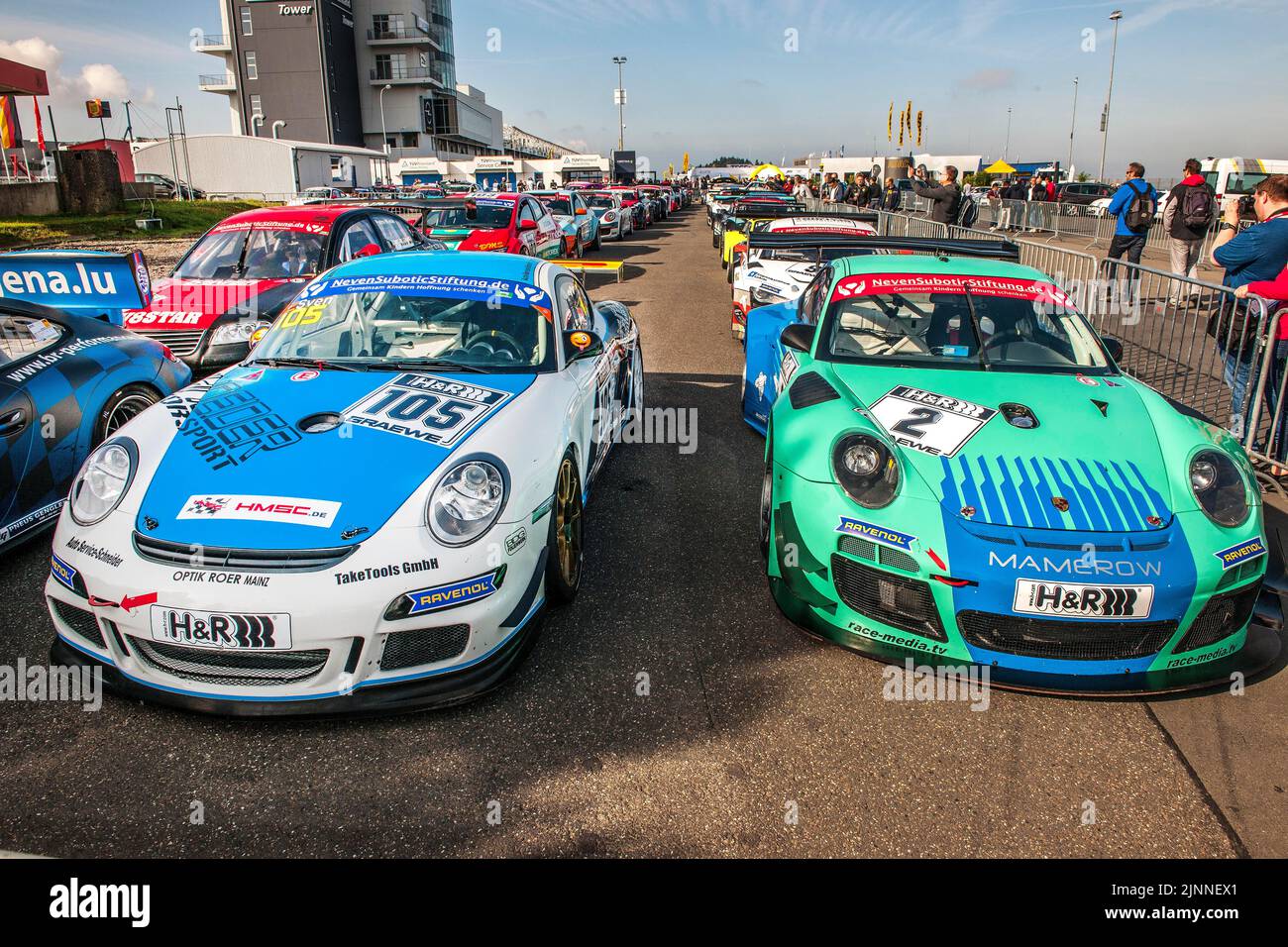 Racing car left Porsche Cayman R right 911 GT3 RSR in Parc Ferme ...
