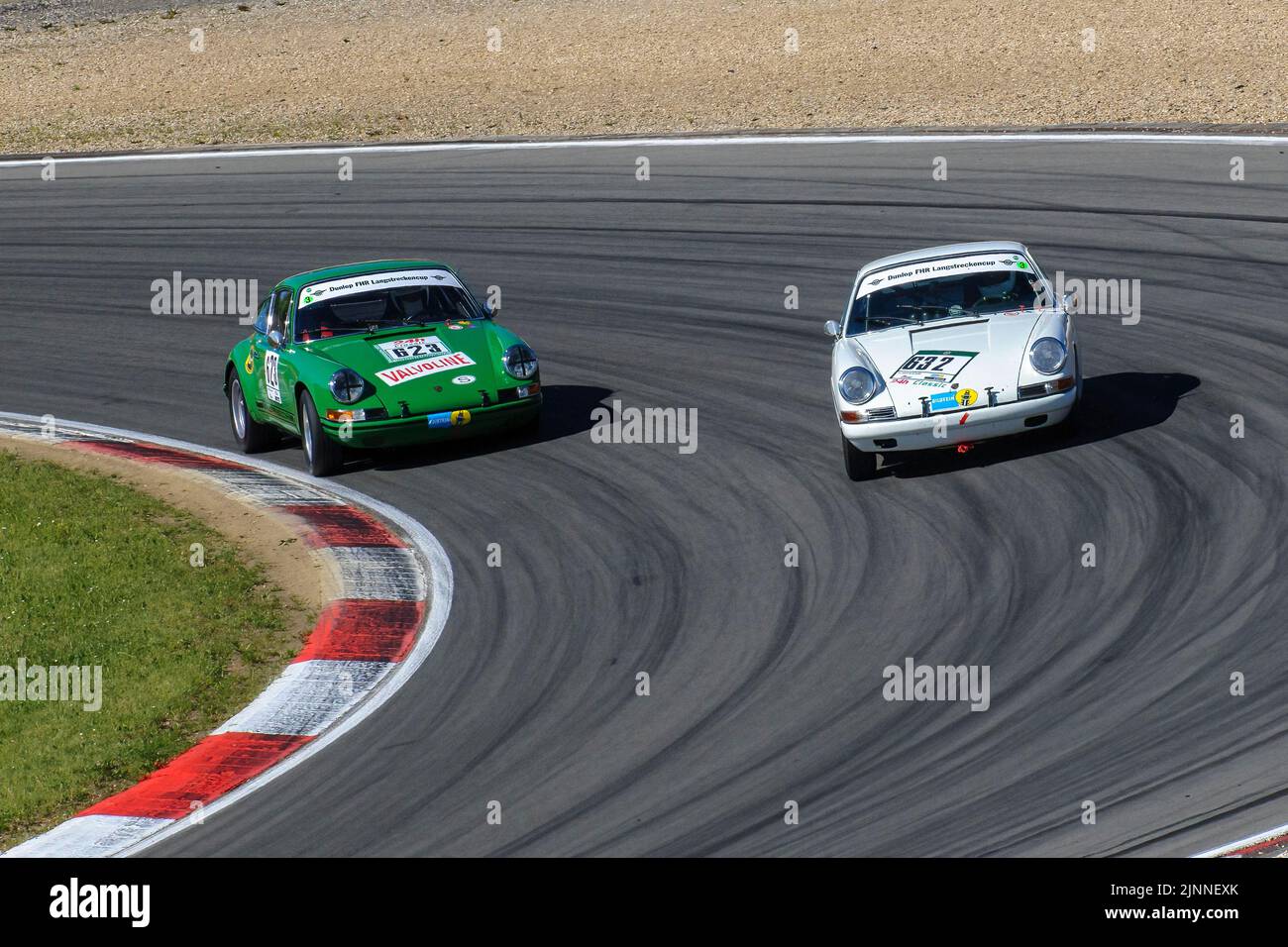 Two historic racing cars Porsche 911 overtaking side by side in curve ...