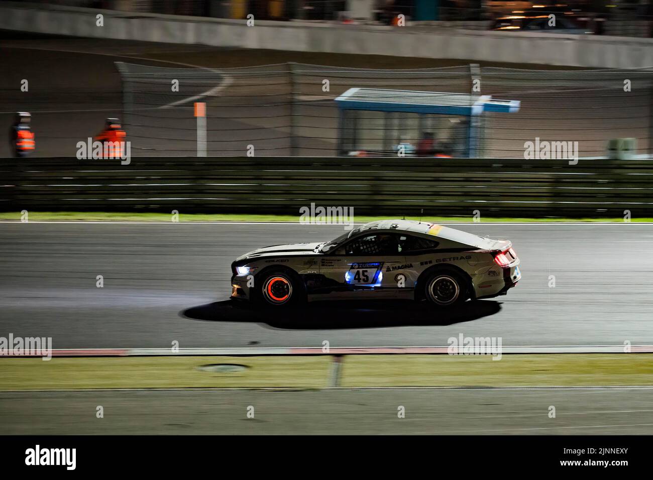 Race car Ford Mustang at night at car race 24-hour race 24h race on ...