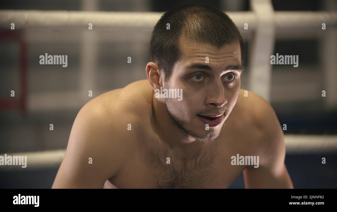 A tired man boxer sitting on the ring Stock Photo - Alamy