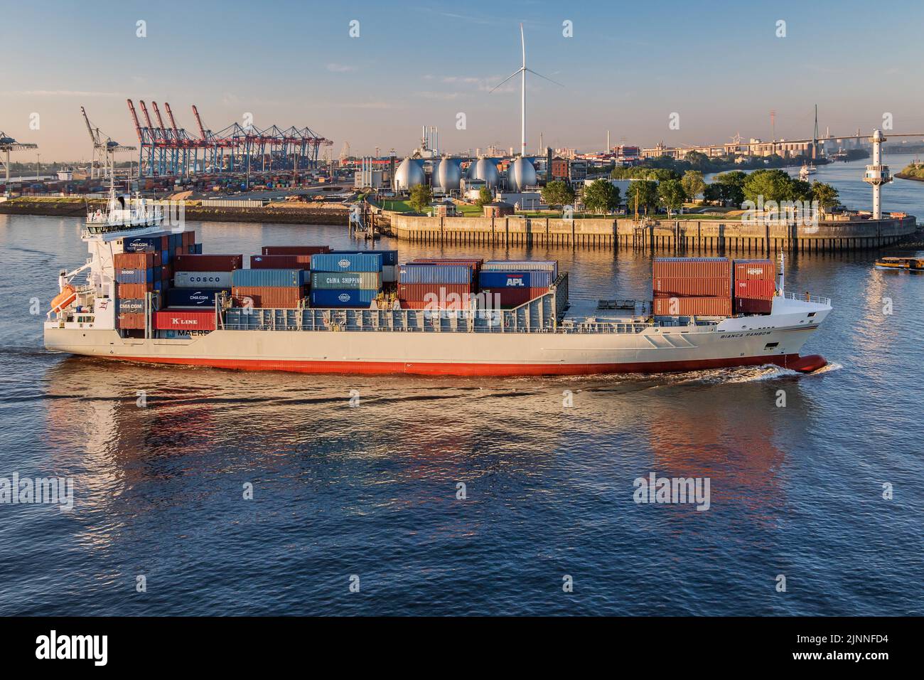 Container ship on the Elbe in the port of Hamburg in the early morning ...