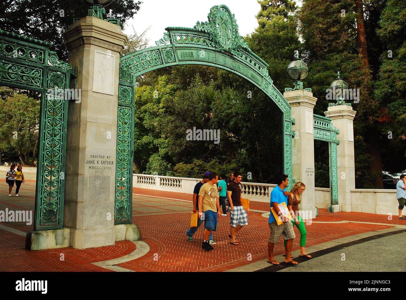 A group of college students walk through the historic Sather Gates an ...