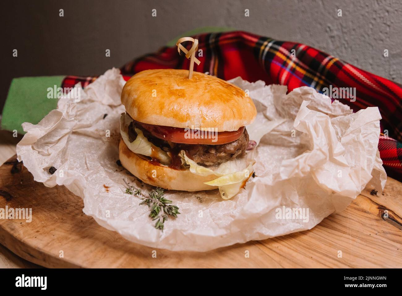 Home-cooked beef burger, juicy patty, puffed bun, lettuce leaf ...