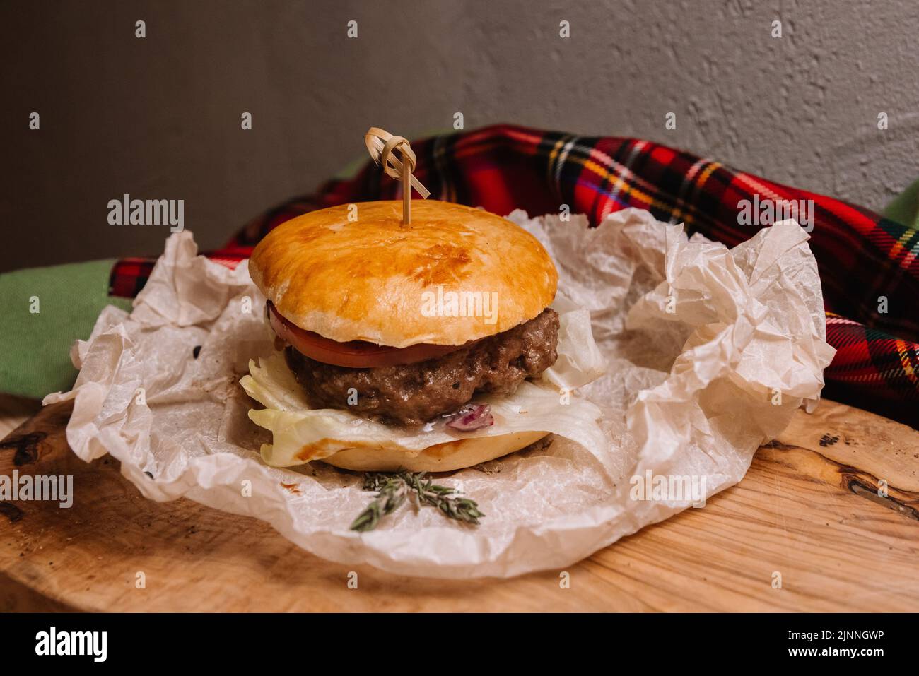 Home-cooked beef burger, juicy patty, puffed bun, lettuce leaf ...
