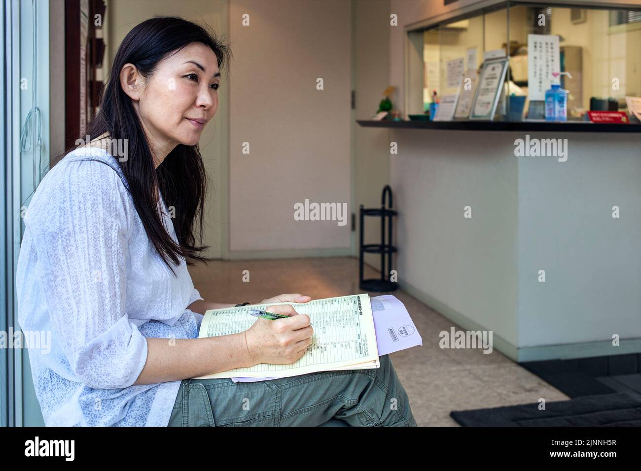 Mature woman in medical clinic waiting room in Ota, Tokyo, Japan Stock ...