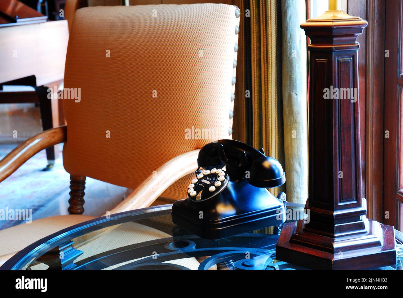 A Vintage Telephone sits on the desk of a classic hotel with antique ...