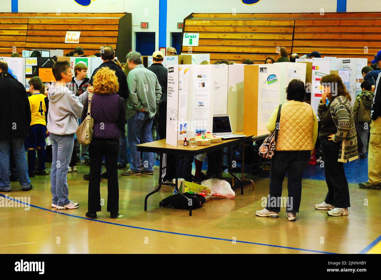 Parents and teachers gather in a gymnasium to see the students' display ...